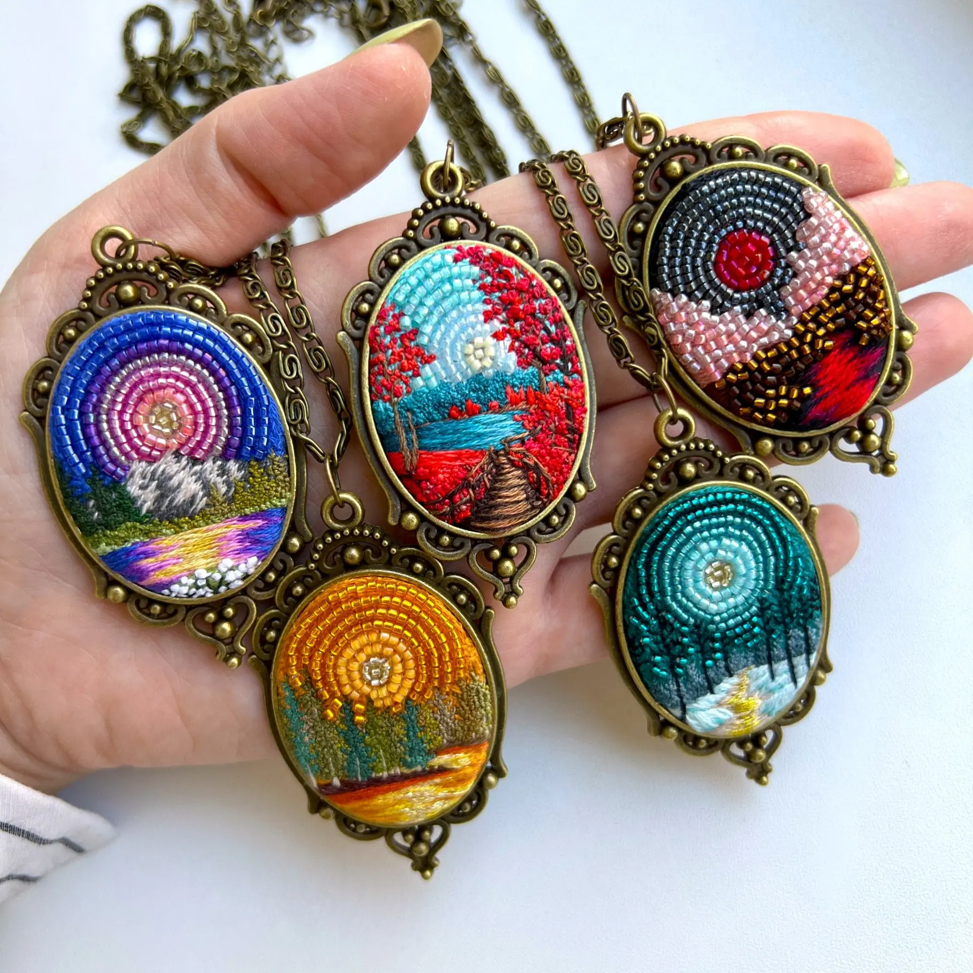 A set of five embroidered pendants, COMMISSIONED WORK - Crealandia