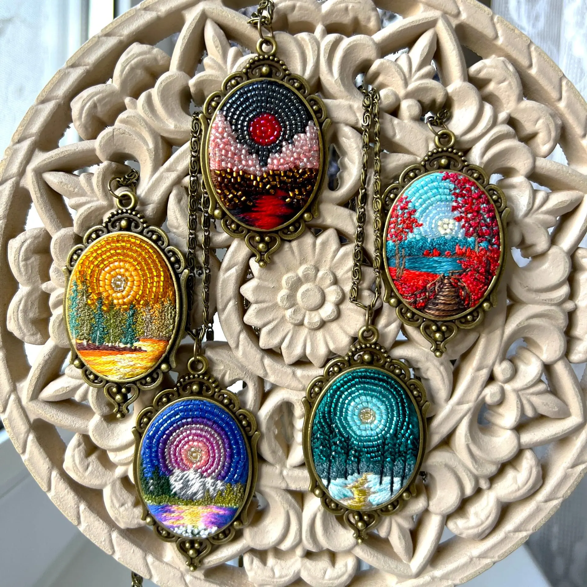 A set of five embroidered pendants, COMMISSIONED WORK - Crealandia