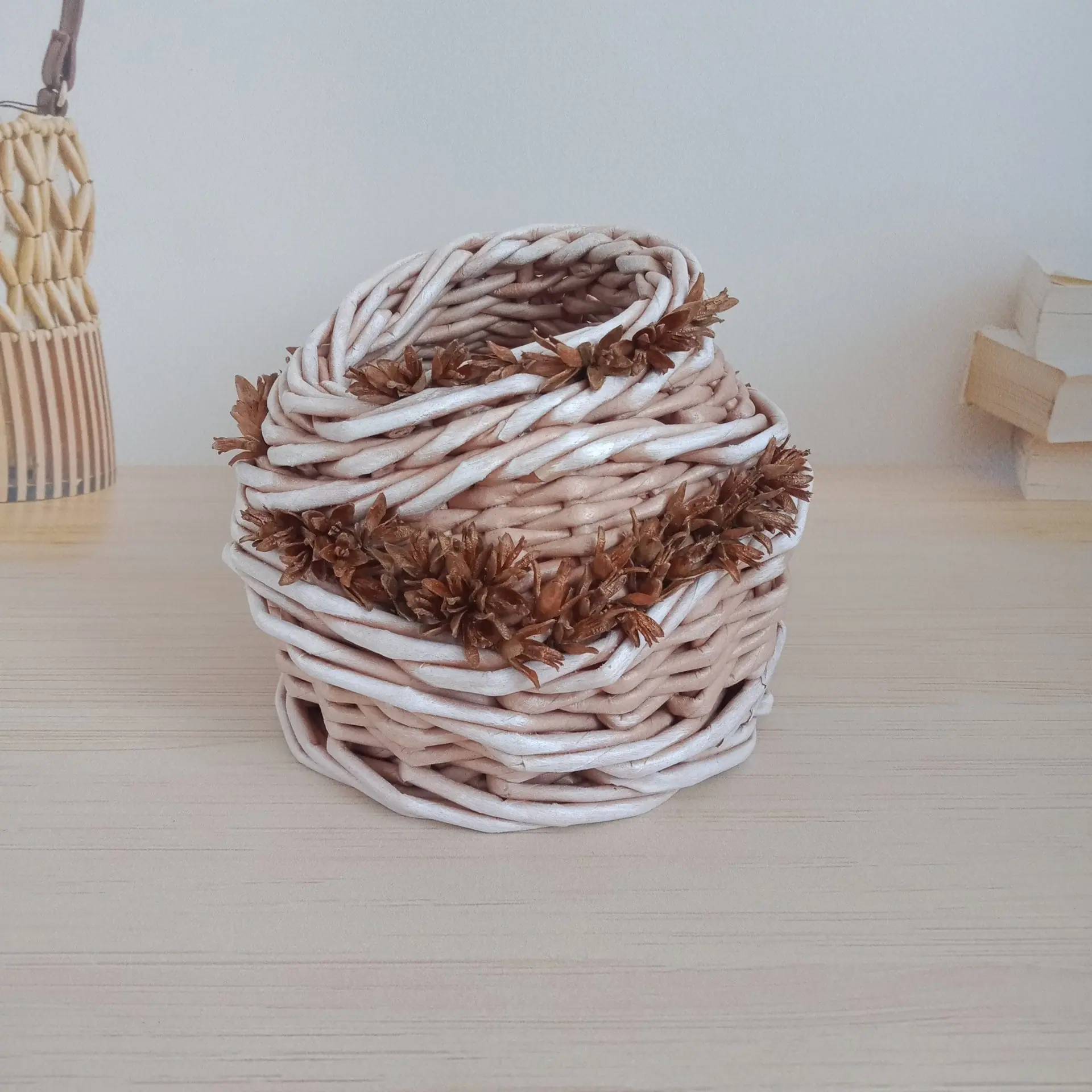 Small unique woven beige basket with thuja cones